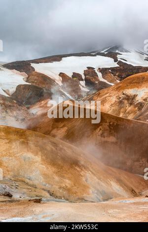 Hot springs and steaming stream between colourful rhyolite mountains ...