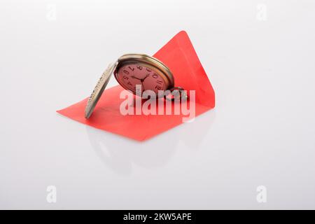 Mechanical pocket watch on a red envelope Stock Photo - Alamy