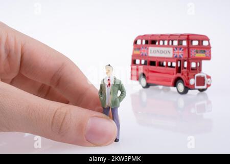 Human figure near a London Bus on a white background Stock Photo - Alamy