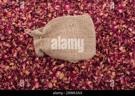 Linen sack placed on Background of dried rose petals Stock Photo - Alamy