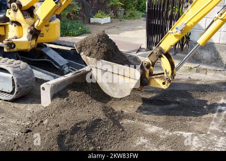 Asphalt laying. Leveling the road Stock Photo - Alamy
