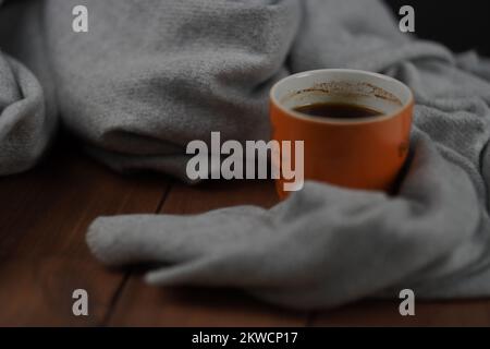 orange Cup withf hot coffee Warm grey scarf a on wooden table. Good ...