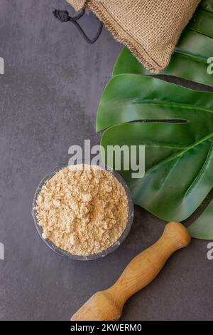 Top view of Gofio, Canarian flour, wood mortar and pestle, sacksful and ...