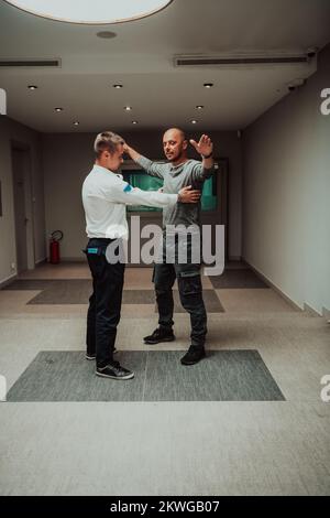 Security guard making body searching procedure with a metal detector on ...