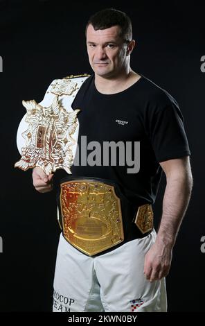 Mirko 'Cro Cop' Filipovic poses for a photograph with his two winners ...