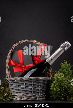 Basket with Christmas gift boxes, champagne, oranges and decor Stock ...