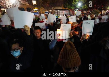 Protesters hold blank papers and placards during a demonstration ...