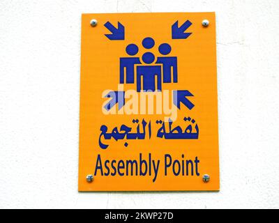 Assembly Point Sign in Arabic and English languages that uses safety ...