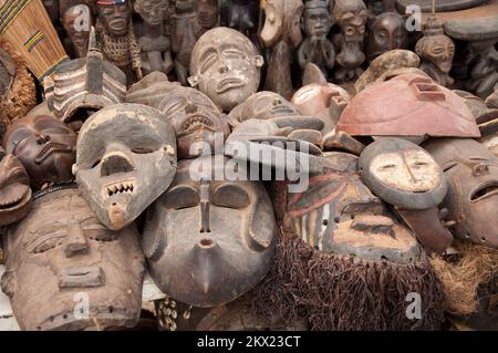 Traditional masks and other wooden souvenirs, market stall, Lubumbashi ...