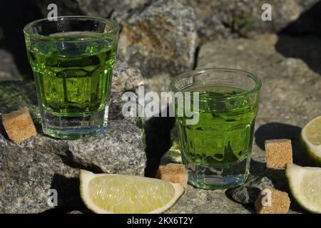 green absinthe drink pattern on the white wooden background with copy ...