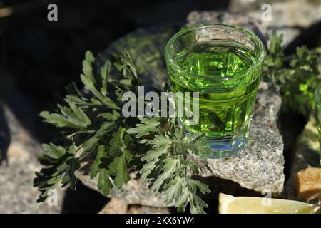 green absinthe drink pattern on the white wooden background with copy ...