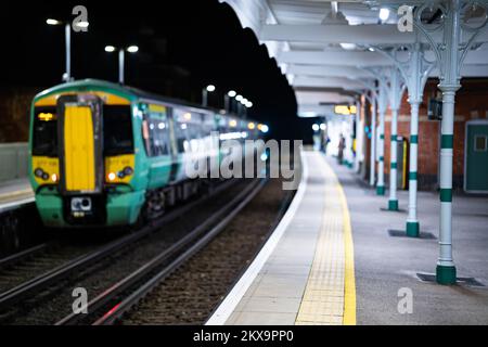 Night scene at small rural train station in West Sussex, England. UK ...
