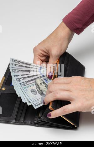 Man puts money out of his wallet Stock Photo - Alamy