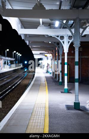Night scene at small rural train station in West Sussex, England. UK ...