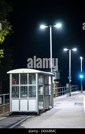 Night scene at small rural train station in West Sussex, England. UK ...
