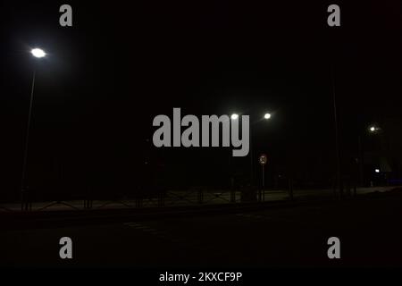 Road next to a crossing at night with cars passing by Stock Photo - Alamy