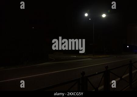 Road next to a crossing at night with cars passing by Stock Photo - Alamy