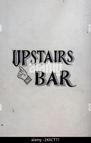 Upstairs bar painted sign Stock Photo - Alamy