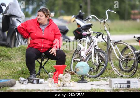 Seller is trying to sell secon hand household items at the Sunday ...