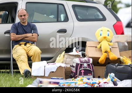 Seller is trying to sell secon hand household items at the Sunday ...