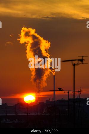 Sunrise in Zagreb, Croatia vith a view at smoke from power plant and ...