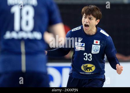 CAIRO, EGYPT - JANUARY 23: Yuto Agarie of Japan and Mathias Gidsel and Simon Hald Jensen of ...