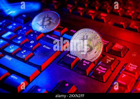 Representations of virtual currency Bitcoin is seen placed on white ...