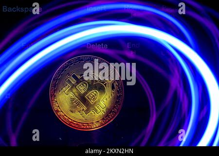 Representations of virtual currency Bitcoin is seen placed on white ...