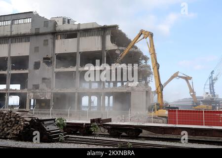 Demolition crane is pictured dismantling old warehouse at city dock in ...