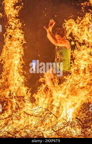 Children jumping through bonfire in Vodnjan, Croatia on 23. June 2021 ...