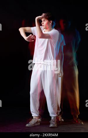 guy moving cheerfully in mixed neon light Stock Photo - Alamy
