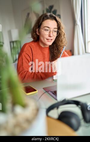 Student having online business course on laptop using e-learning ...