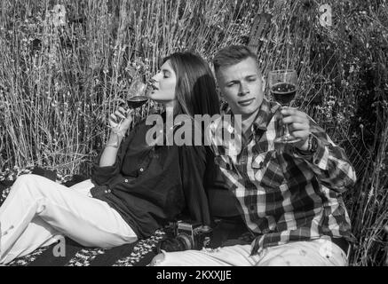 total relax. opium. spring countryside. lovers drink red wine in flower ...