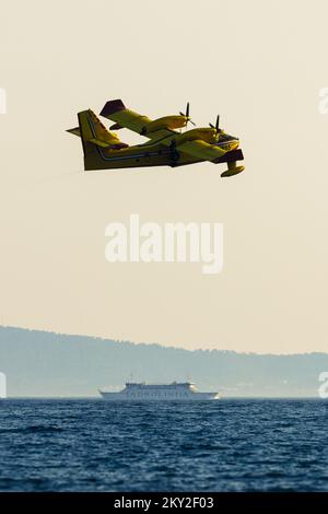 Canadair collects water from the Adriatic Sea in front of Stobrec, near ...
