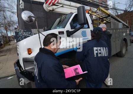 A Con Edison emergency repair red truck at a utility manhole in the ...
