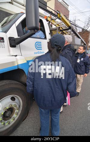 A Con Edison emergency repair red truck at a utility manhole in the ...