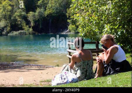 Tourists enjoy at the Plitvice Lakes National Park in Croatia, on ...