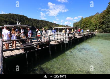 Tourists enjoy at the Plitvice Lakes National Park in Croatia, on ...