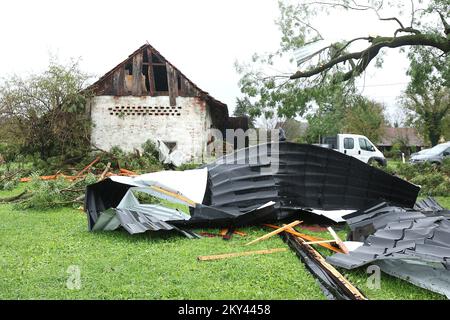 Parts of roofs and roofing tiles scattered around after a heavy storm ...