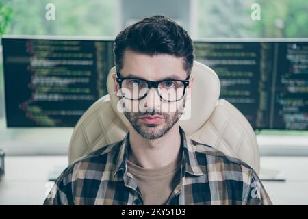 Photo of serious confident programmer wear earphones writing music ...
