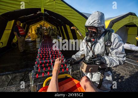 Emergency response personnel check for radiological activity on a ...