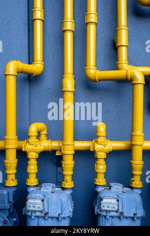 Natural gas meter with yellow pipes measuring gas consumption. An ...