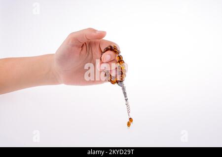 Hand holding a tespih on a white background Stock Photo - Alamy