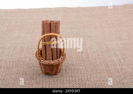 Bundle of cinnamon sticks on a linen canvas background Stock Photo - Alamy