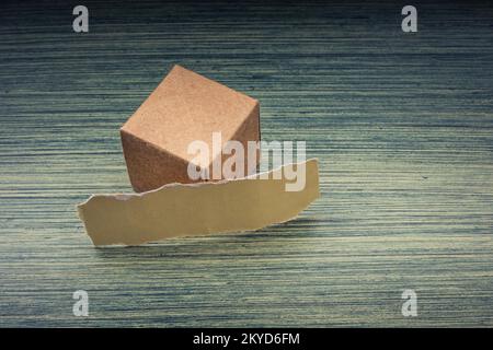 Torn paper and a paper box cube on wooden texture Stock Photo - Alamy