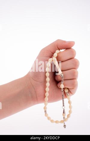 Hand holding a tespih on a white background Stock Photo - Alamy
