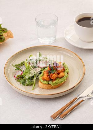 Gourmet appetizer of shrimp and avocado salad served in avocado skin ...
