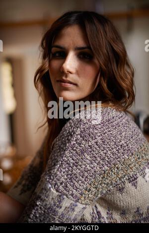 Young serious beautiful brunette woman with sincere emotions wearing ...