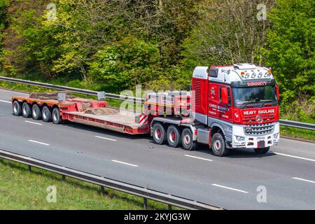 Low loader articulated trailer & hgv lorry truck loaded with wide ...