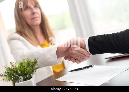 Businesswoman and businessman shaking hands (lorem ipsum text used ...